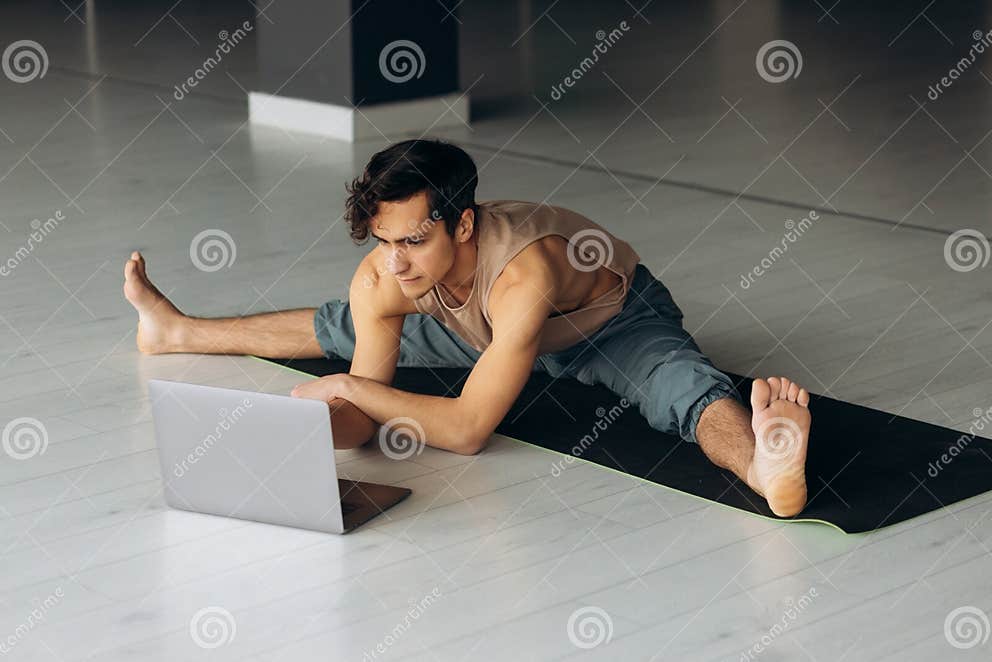 Portrait of Confident Young Man Doing the Splits while Watching ...