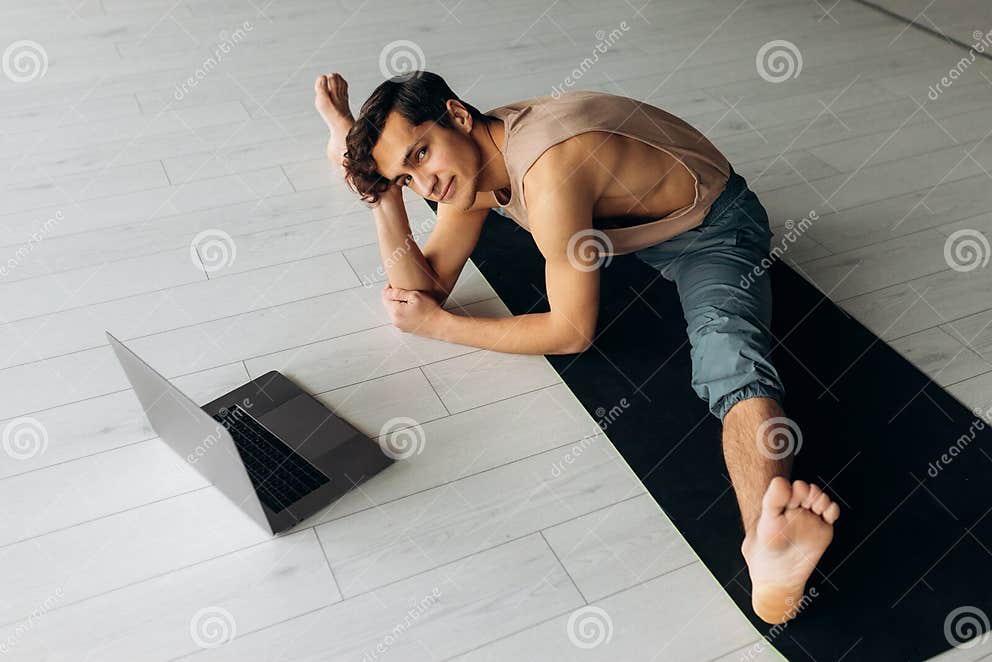 Portrait of Confident Young Man Doing the Splits while Watching ...