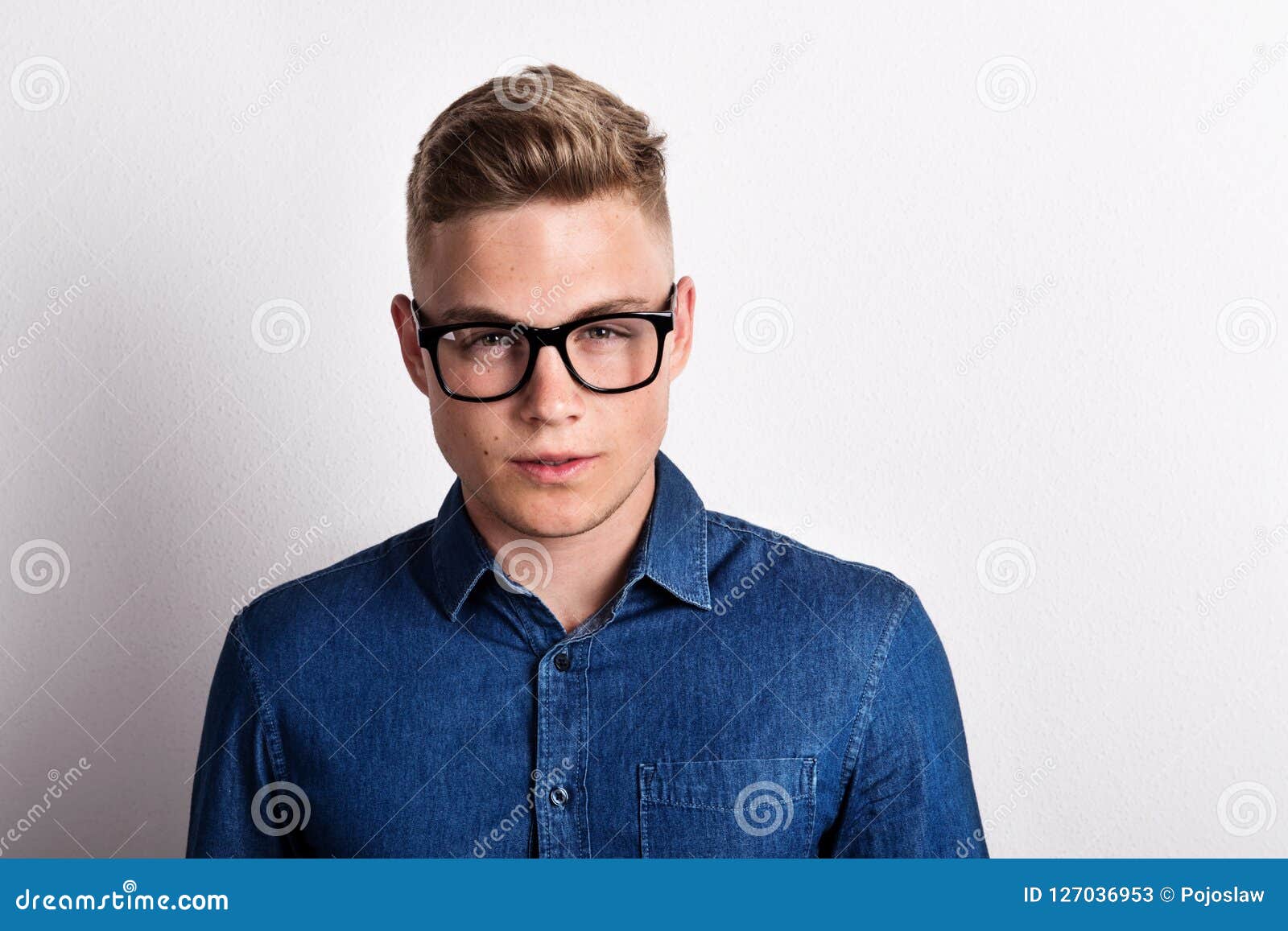 Portrait of a Confident Young Man in a Studio, Wearing Blue Shirt. Copy ... Portrait of a Confident Young Man in a Studio, Wearing Blue Shirt. Copy ...