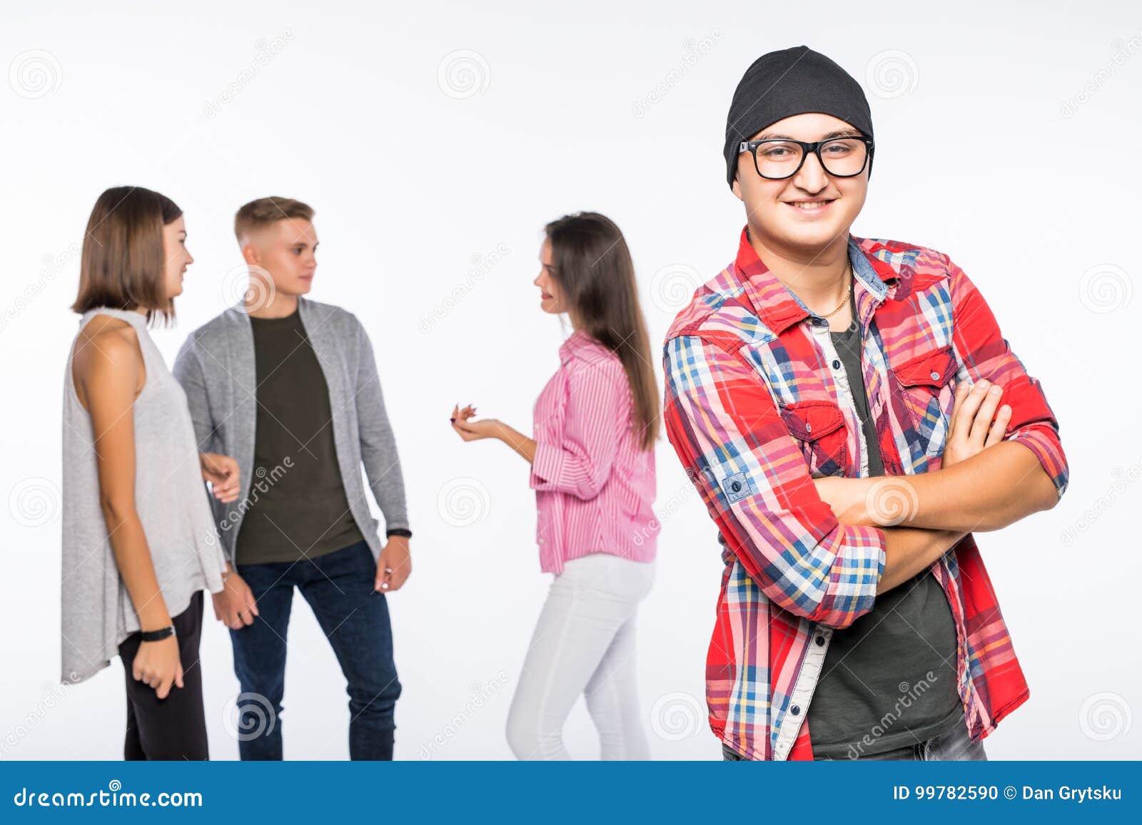 Portrait Of Confident Man With Group Of People Talking In Background ... Portrait Of Confident Man With Group Of People Talking In Background ...