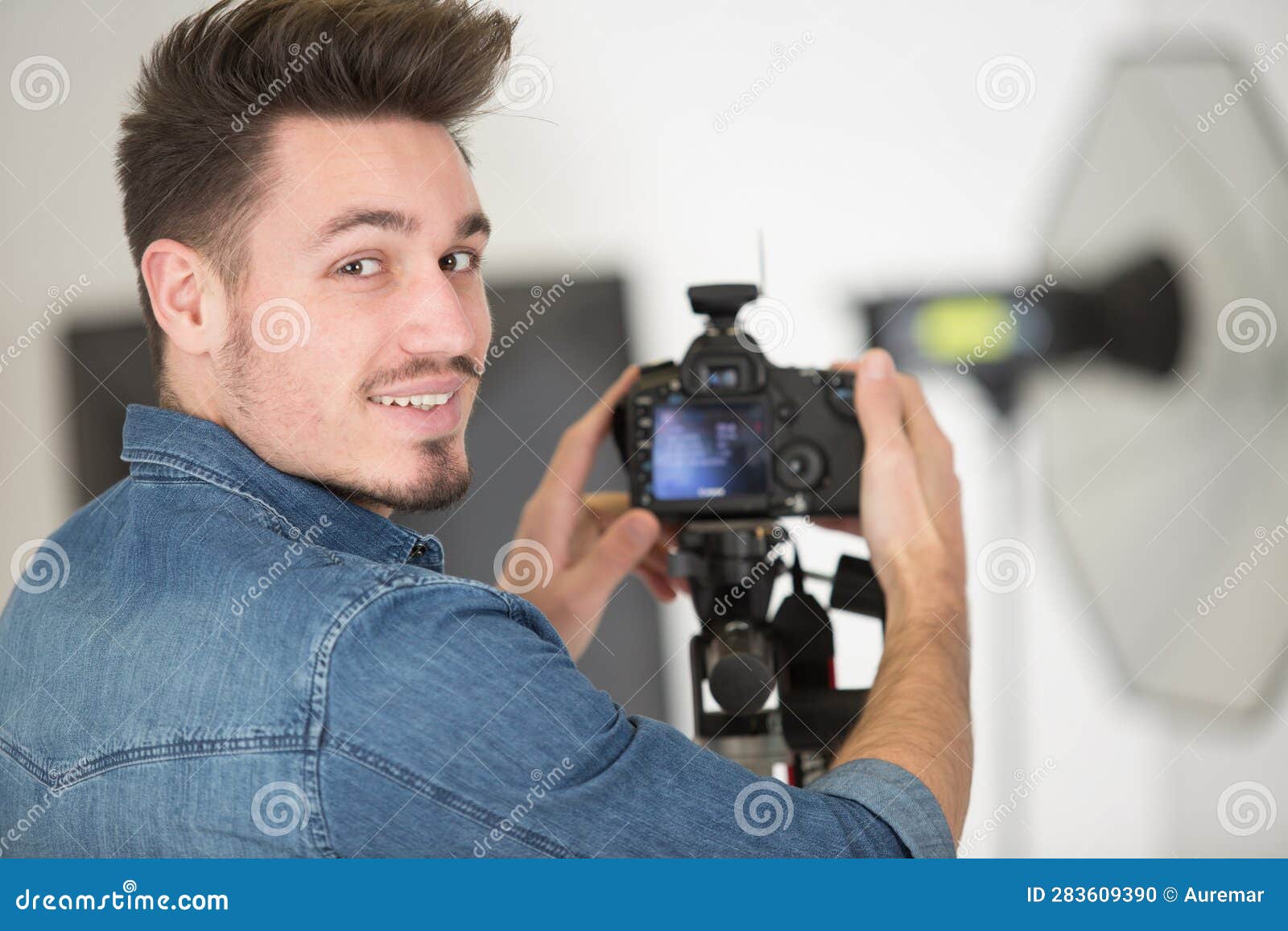 Portrait Confident Young Photographer in Studio Stock Photo - Image of ...