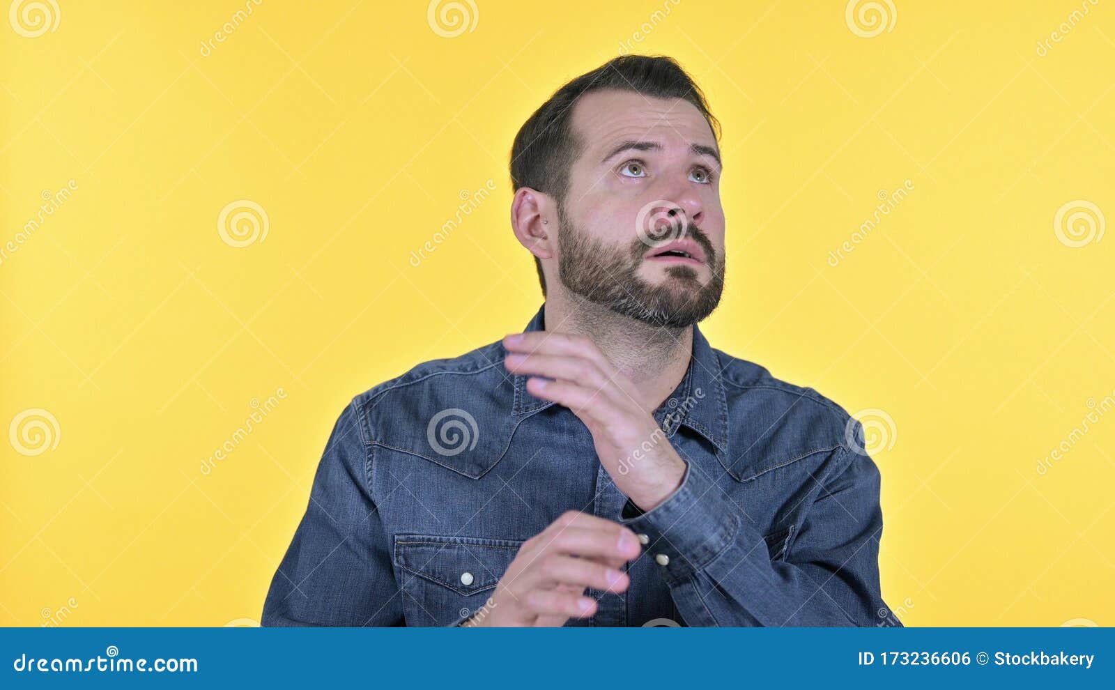 The Portrait of Confused Scared Young Man Looking Side Ways, Yellow ...