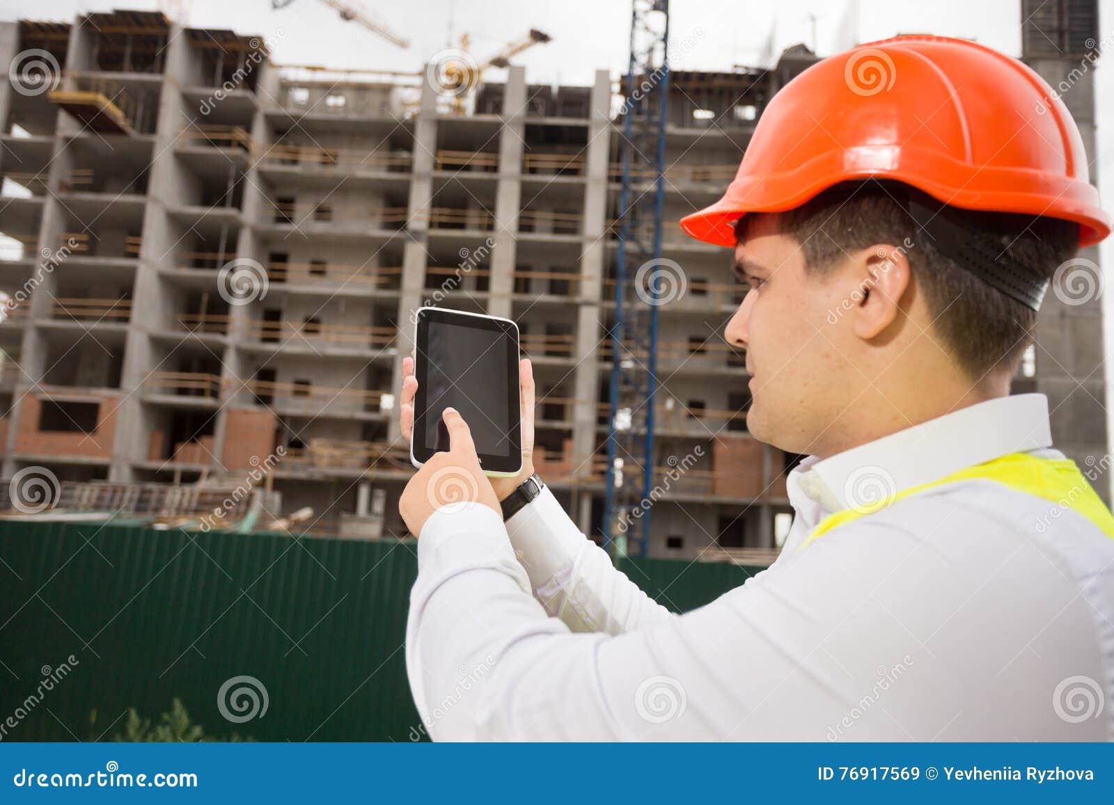 Portrait of Construction Engineer Using Digital Tablet on Building Site ...