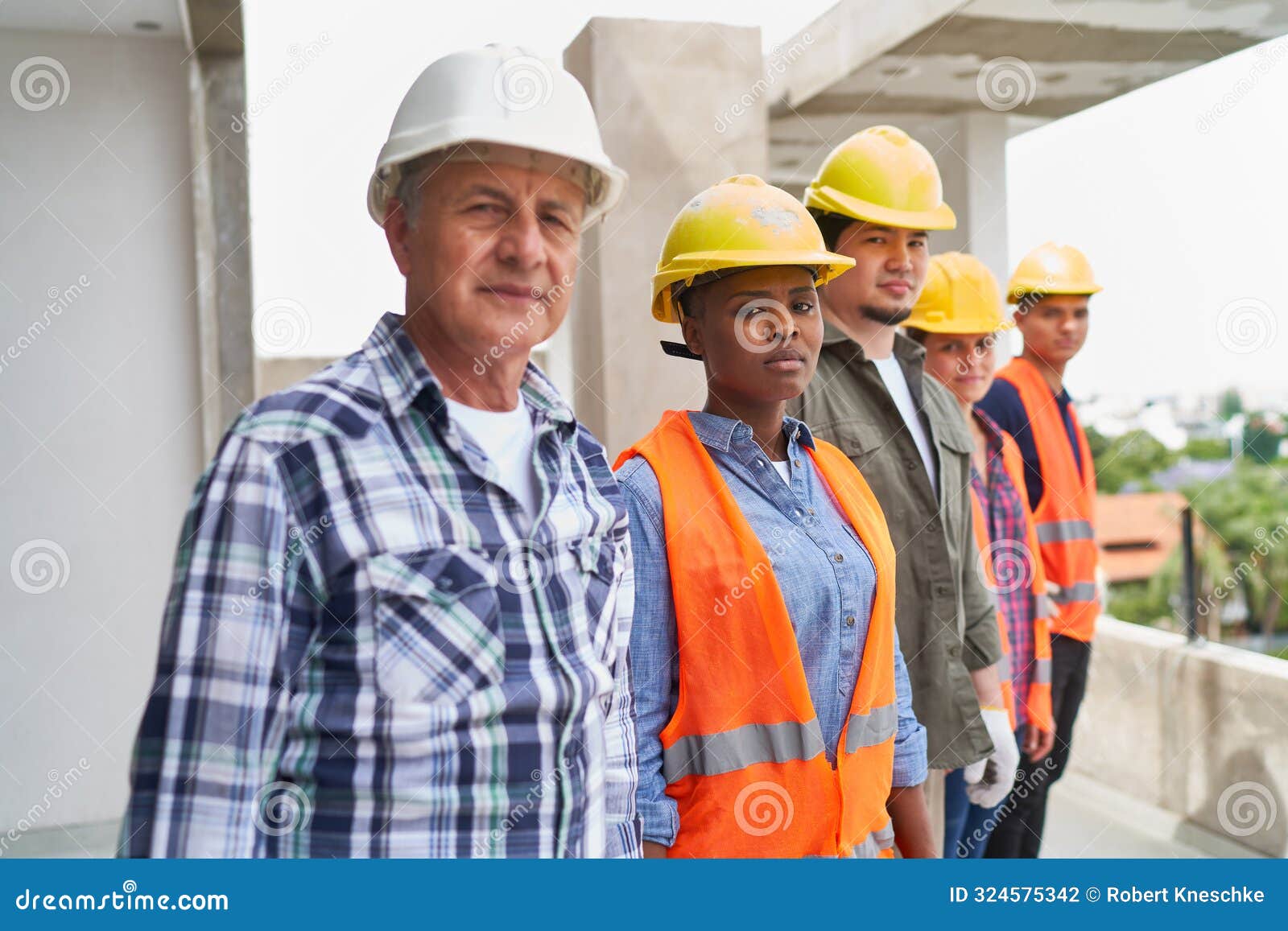 Portrait of Construction Team in Workwear Standing Together at ...