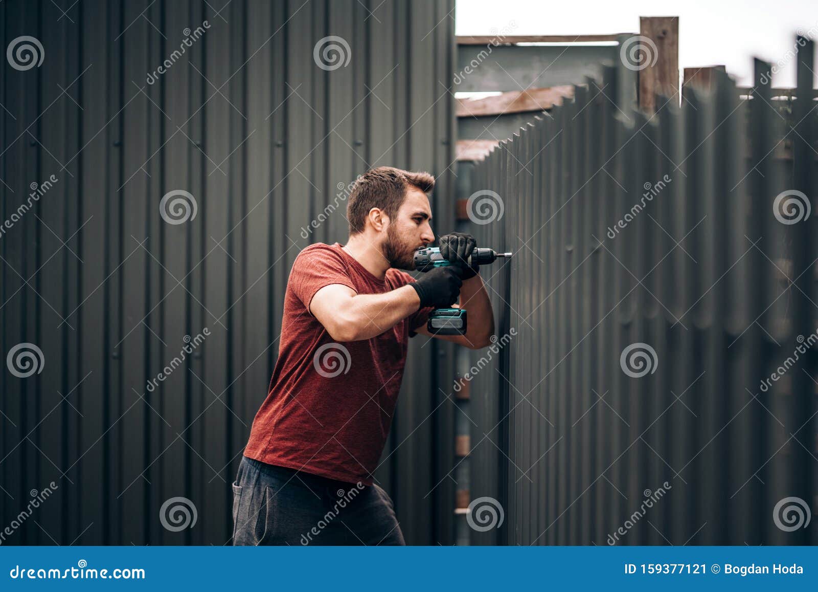 Construction Worker Using Screwdriver for Fastening and Drilling Stock ...