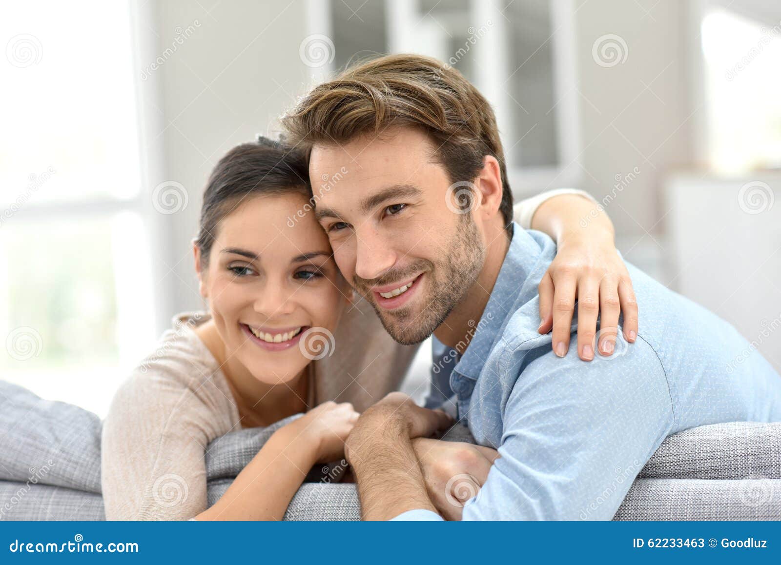 Portrait of Couple Sitting on Sofa and Hugging Stock Image - Image of ...