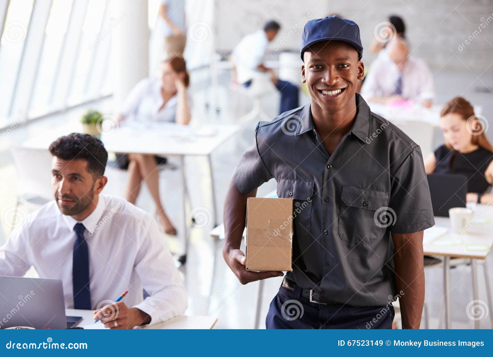 Portrait of Courier Collecting Package from Busy Office Stock Image ...