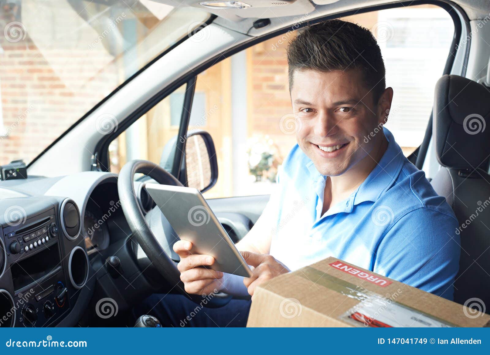 Portrait of Courier with Digital Tablet in Van Delivering Package To ...