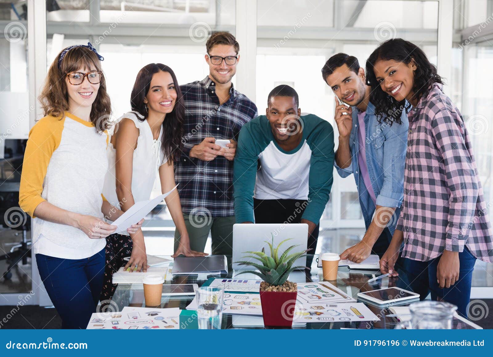 Portrait of Creative Business Team Standing Around Table Stock Photo ...