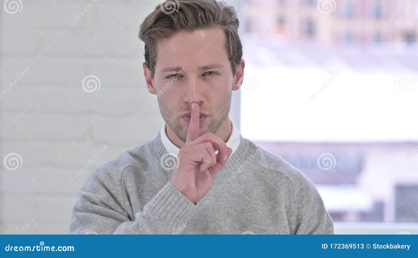 Portrait of Creative Young Man Putting Finger on Lips Stock Image ...