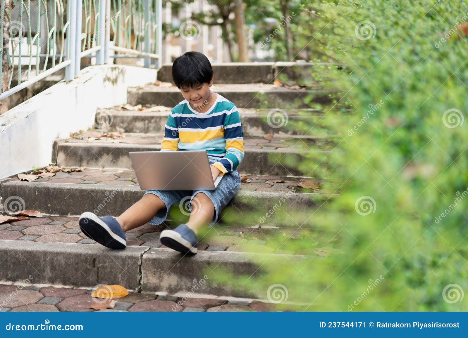 Portrait of Cute Asian Boy Studying or Playing Game with Laptop ...