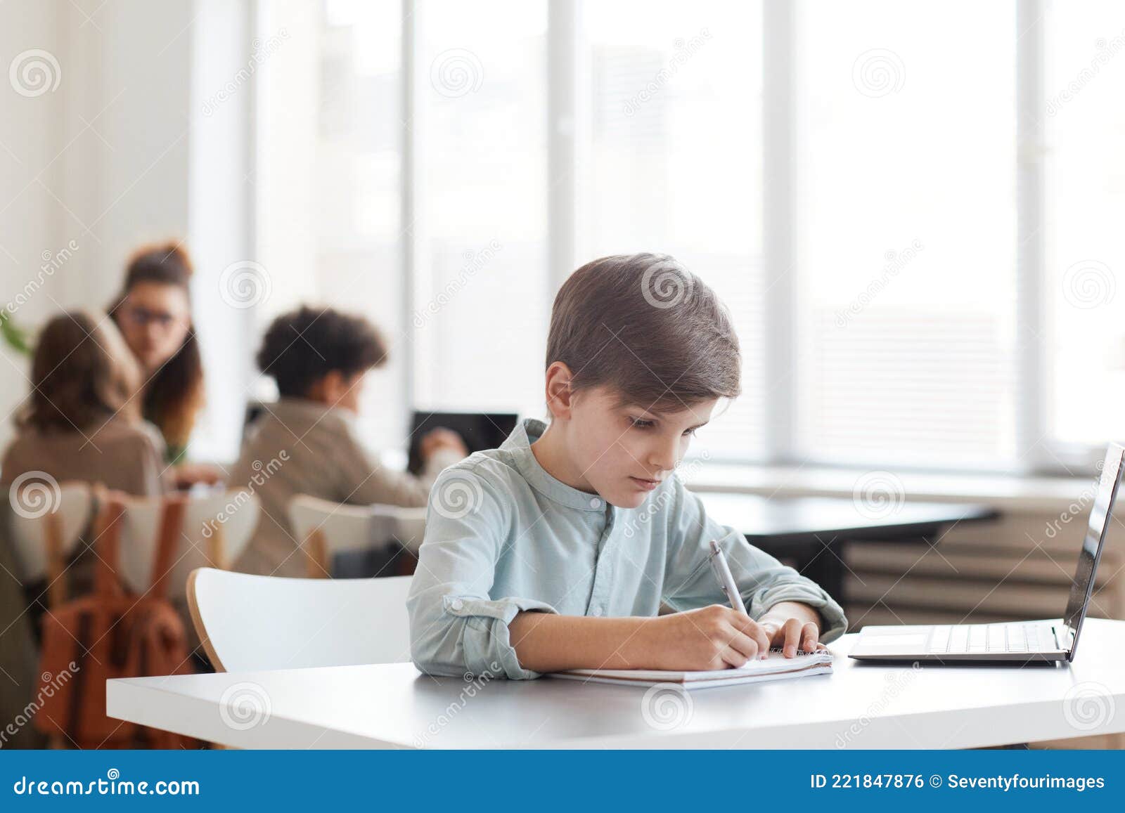 Boy Reading Book in School stock photo. Image of girls - 221847876