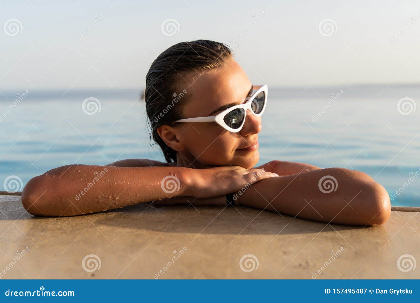 Portrait The Young Woman In Swimming Pool With Sunglasses Stock Image