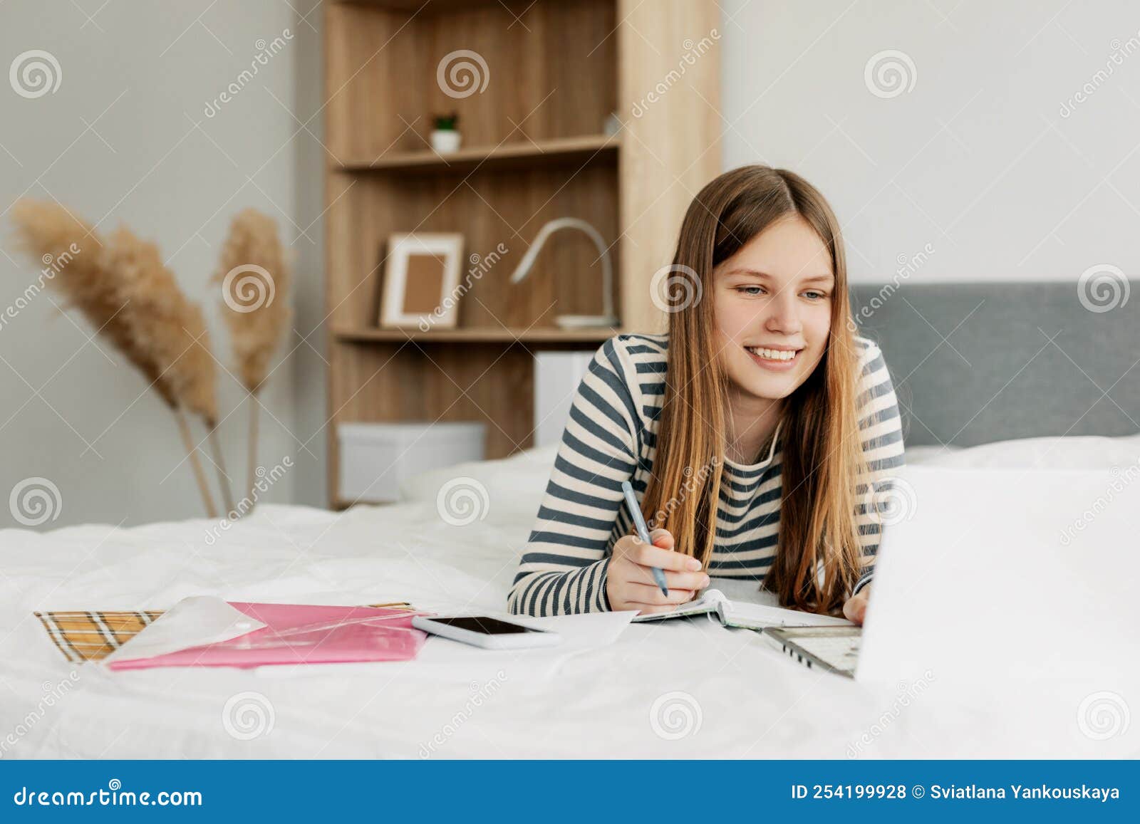 Portrait of a Cute Girl Student Preparing for Lectures Using a Laptop ...