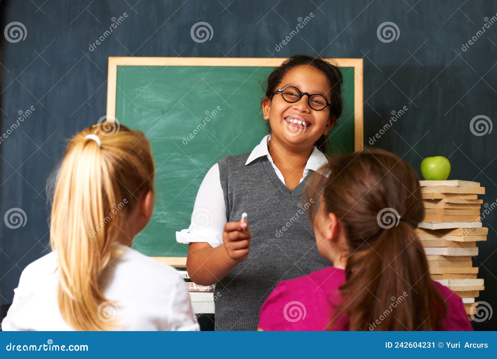 Shes Happy To Help Her Friends. Portrait Of A Cute Girl Teaching Her ... Shes Happy To Help Her Friends. Portrait Of A Cute Girl Teaching Her ...