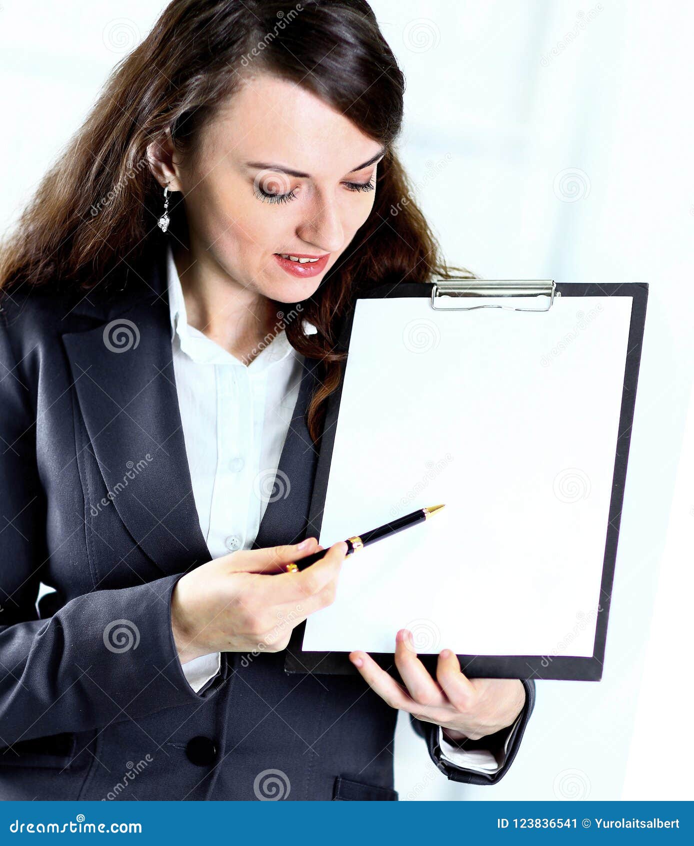 Portrait of a Cute Young Business Woman with the Work Plan Smiling in ... Portrait of a Cute Young Business Woman with the Work Plan Smiling in ...