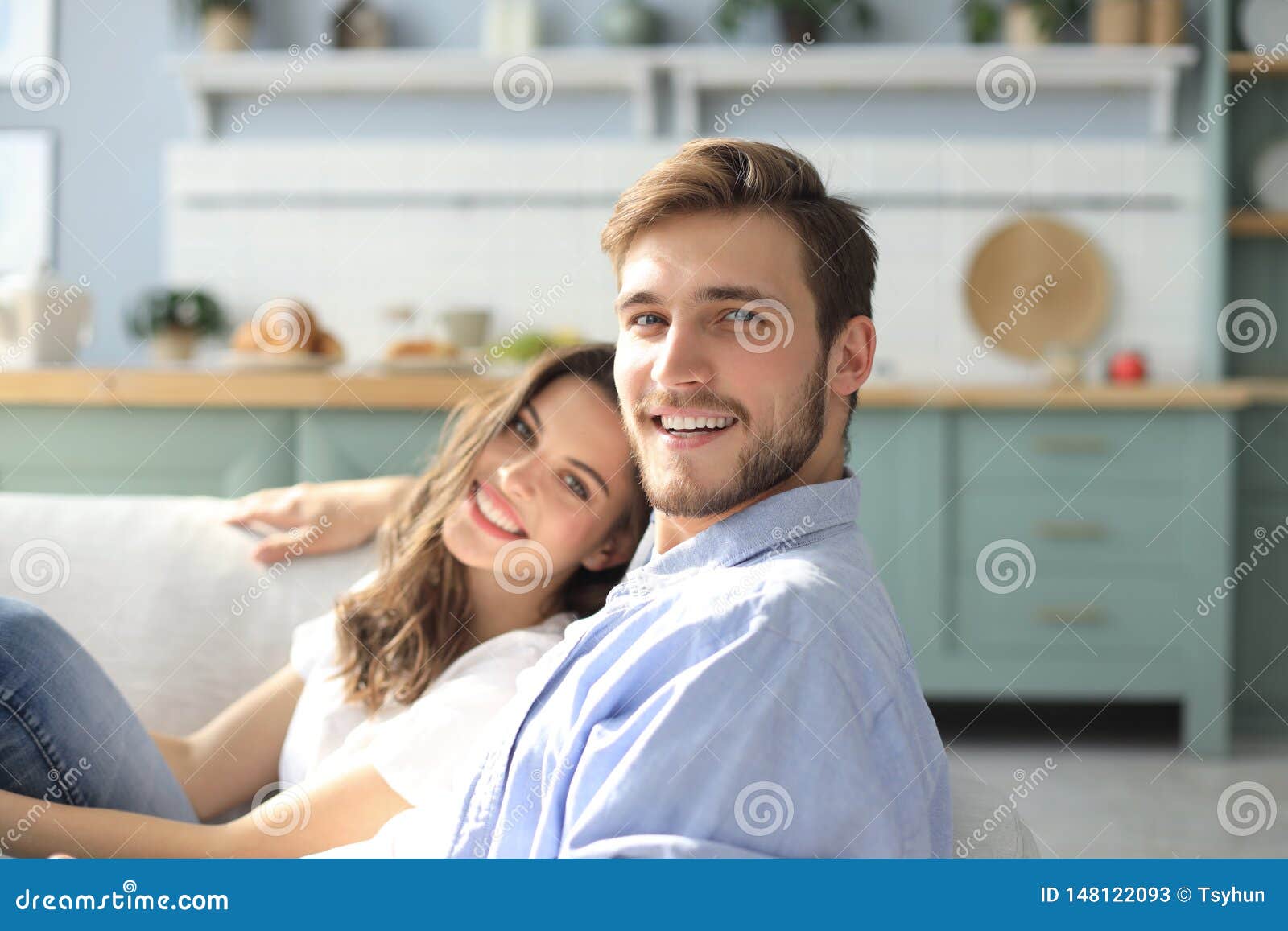 Portrait of Cute Young Couple Sitting in Sofa Stock Image - Image of ...