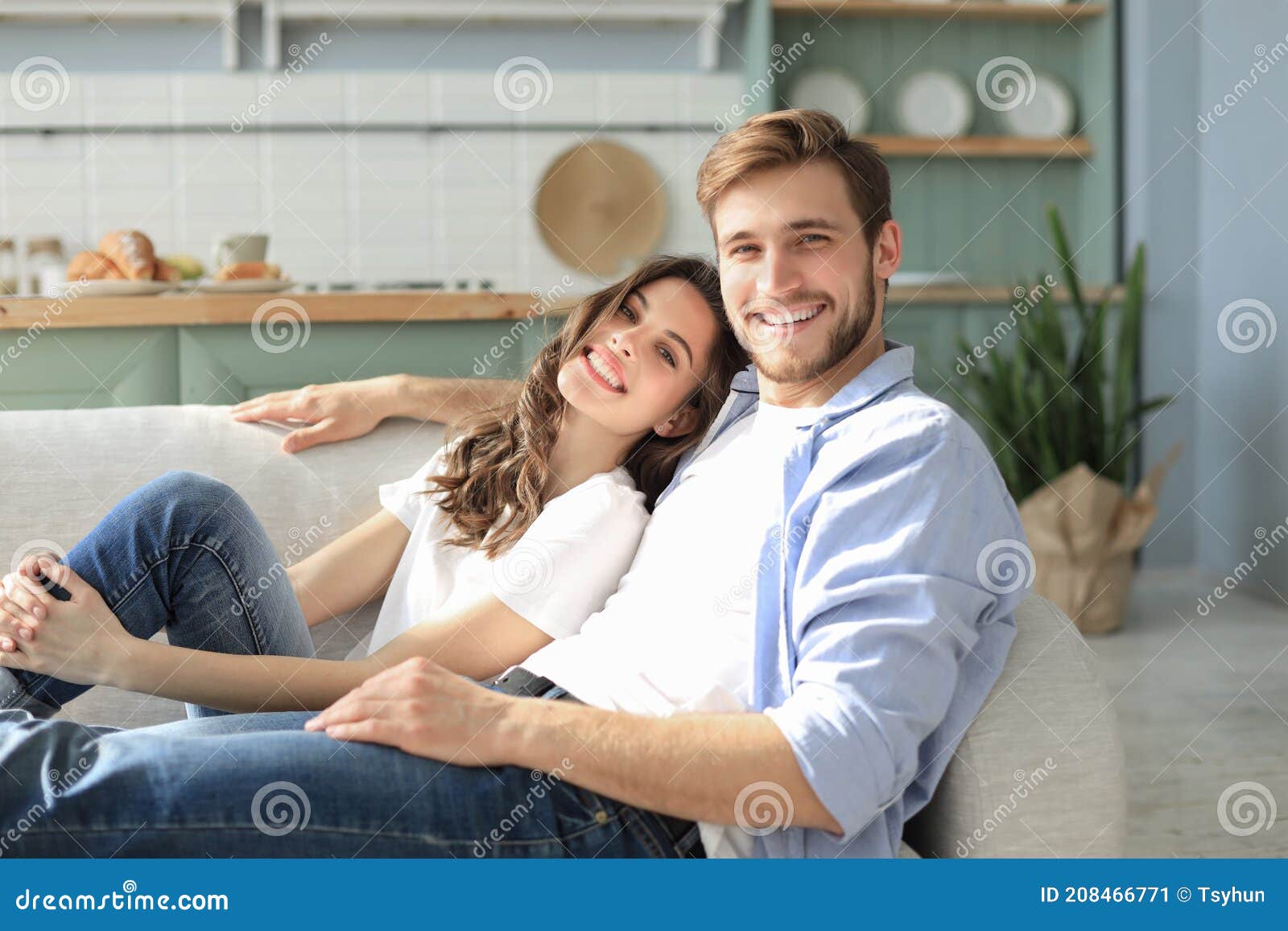 Portrait of Cute Young Couple Sitting in Sofa Stock Image - Image of ...