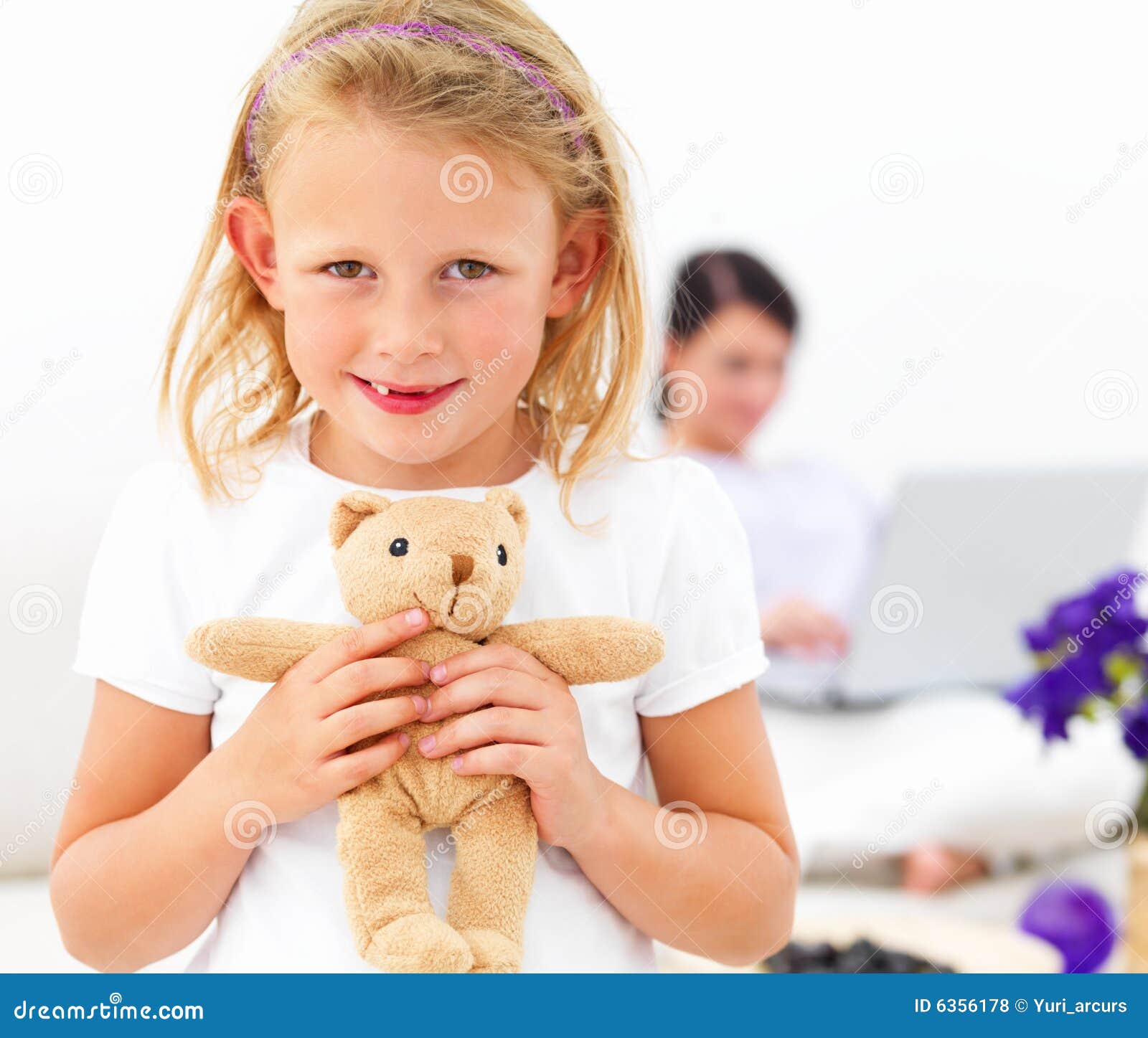 Portrait of a Cute Young Girl Holding Toy Stock Photo - Image of home ... Portrait of a Cute Young Girl Holding Toy Stock Photo - Image of home ...