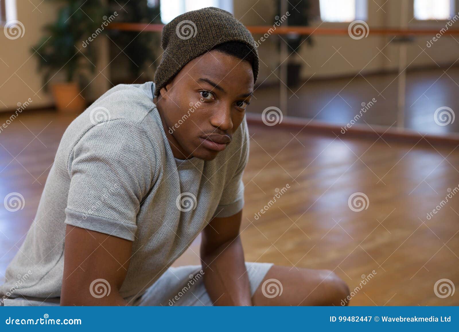 Portrait of Dancer Crouching in Studio Stock Image - Image of flooring ...