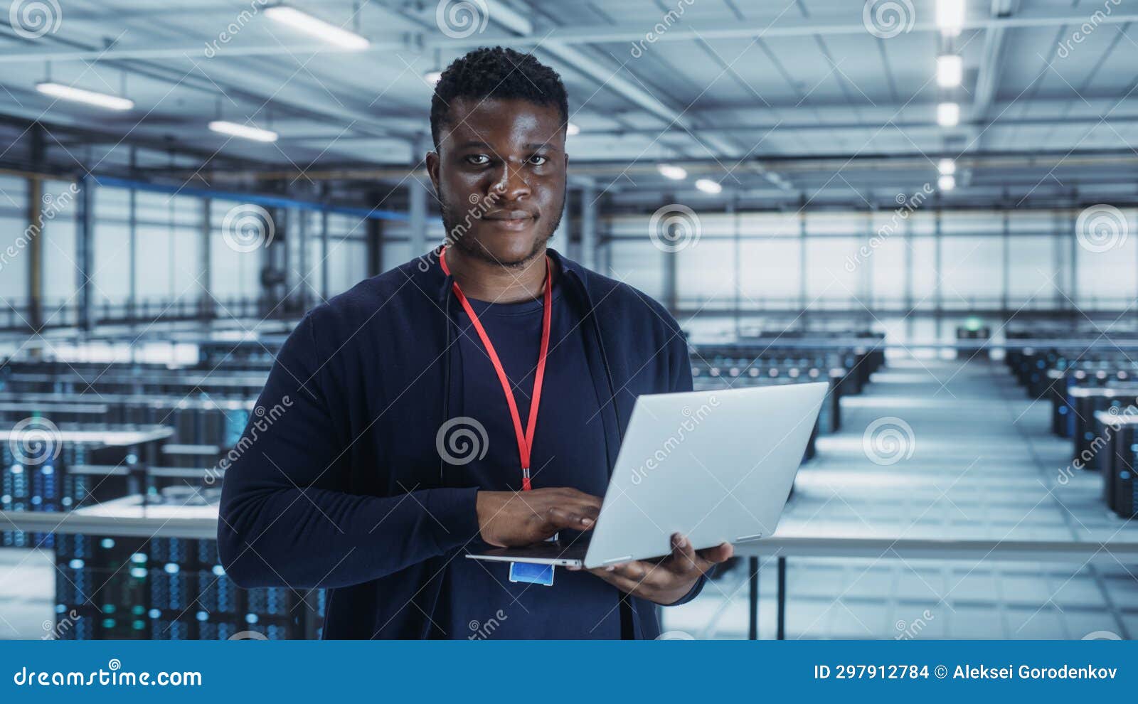 Portrait of a Data Center Engineer Using Laptop Computer. Server Room ...