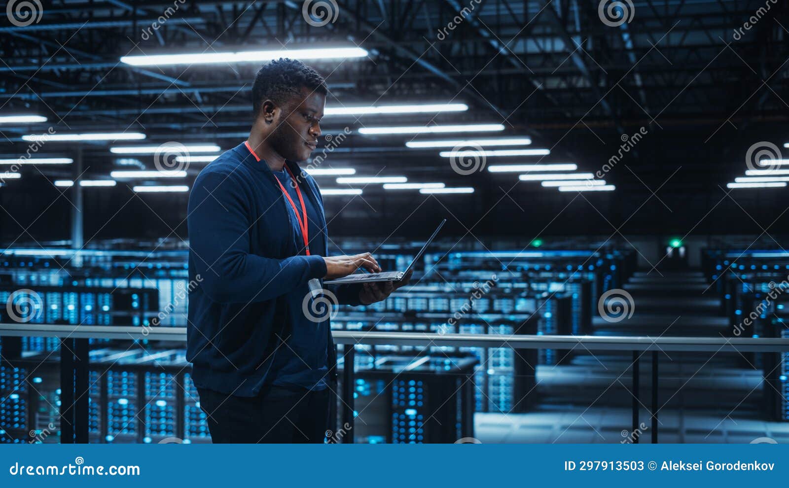 Portrait of a Data Center Engineer Using Laptop Computer. Server Room ...