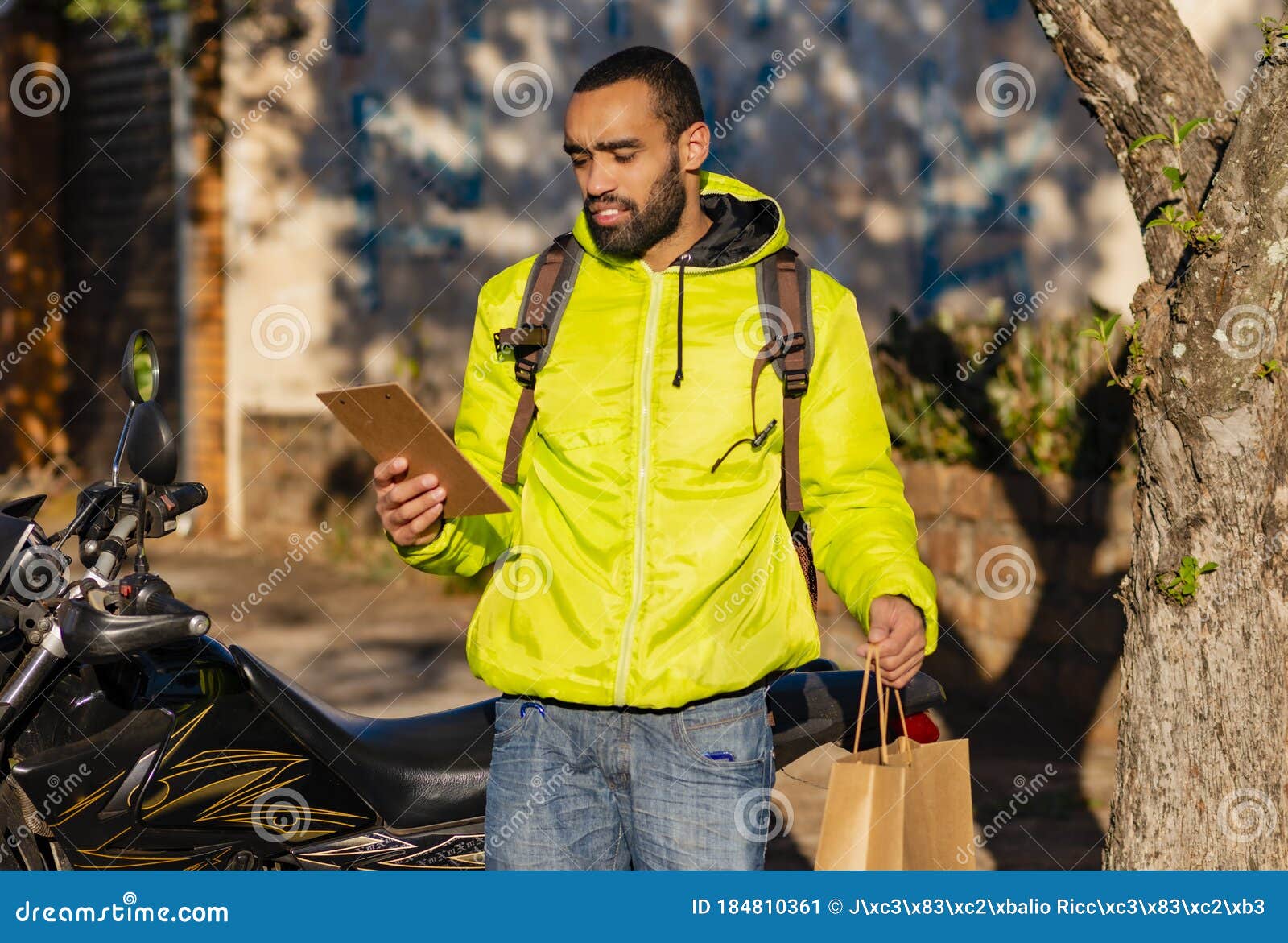 Portrait of Delivery Man in Front of the Delivery Place Checking ...