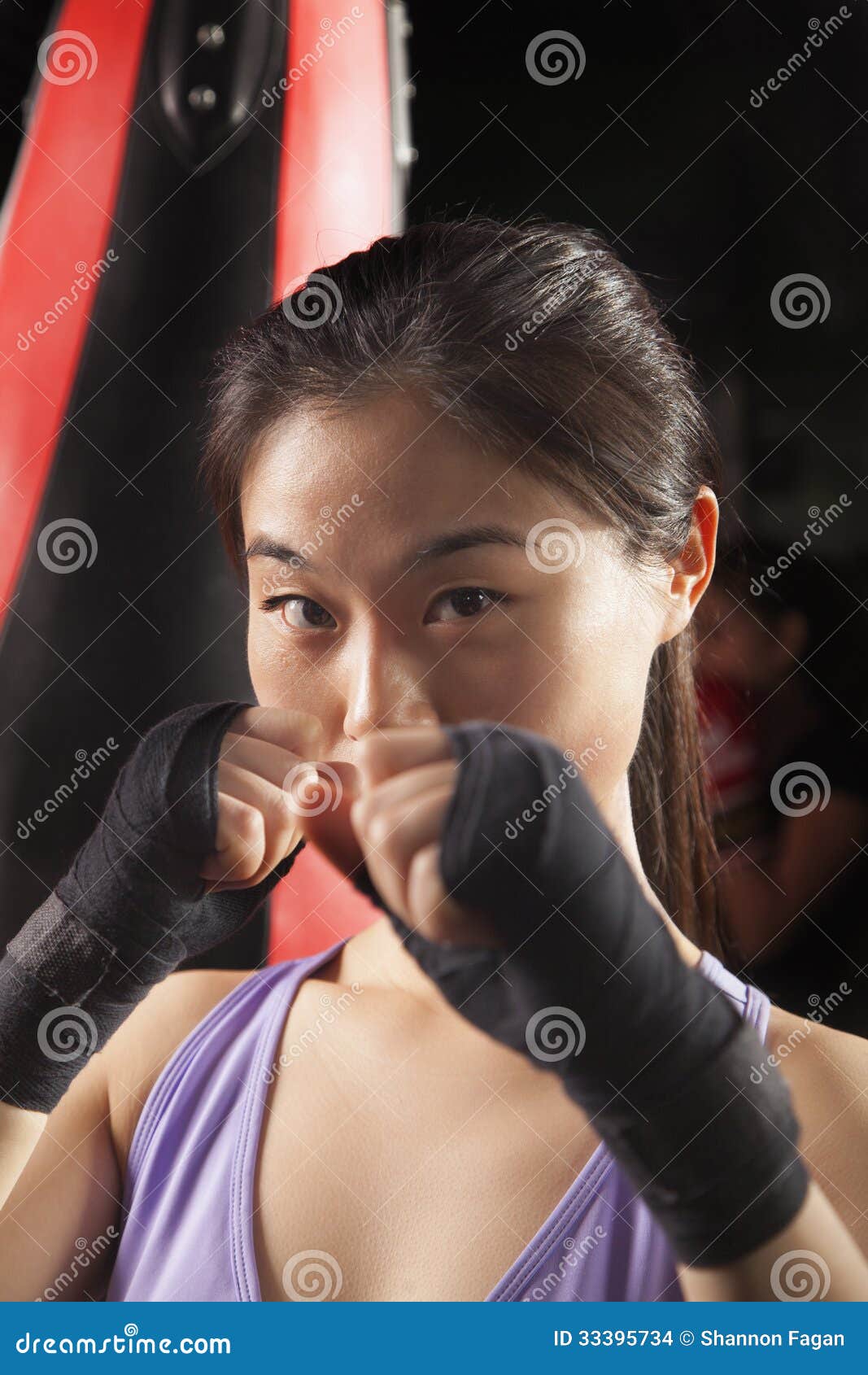 Portrait of Determined Female Boxer in Fighting Stance Looking at ...