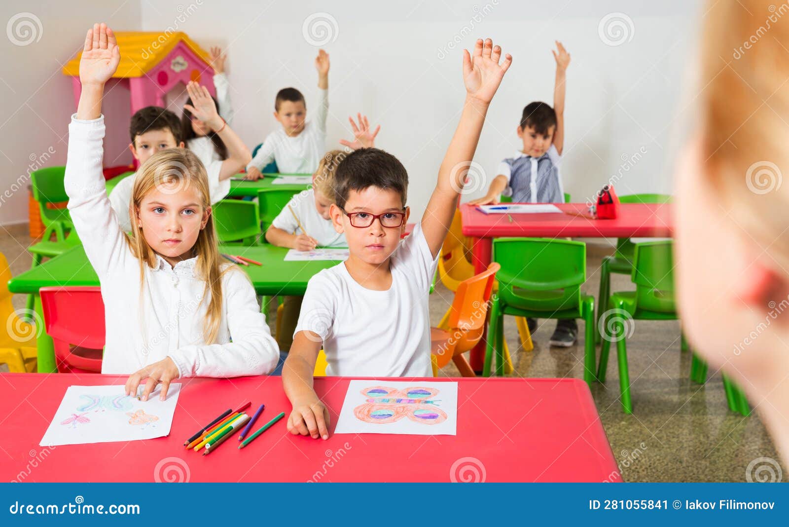 Diligent Schoolchildren with Hands Raised in Classroom Stock Image ... Diligent Schoolchildren with Hands Raised in Classroom Stock Image ...