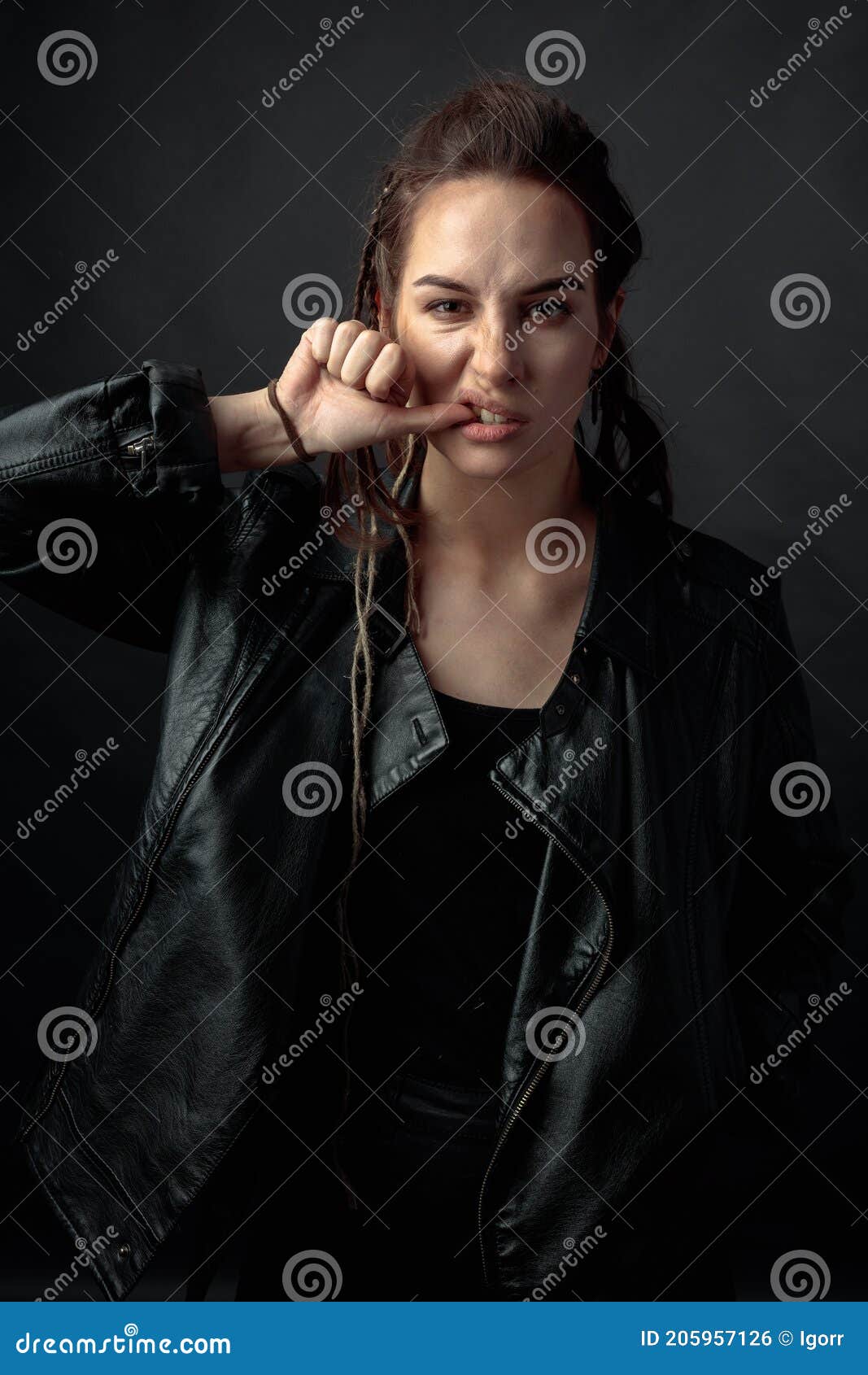 Portrait Of A Displeased Woman Wearing A Black Leather Jacket Stock