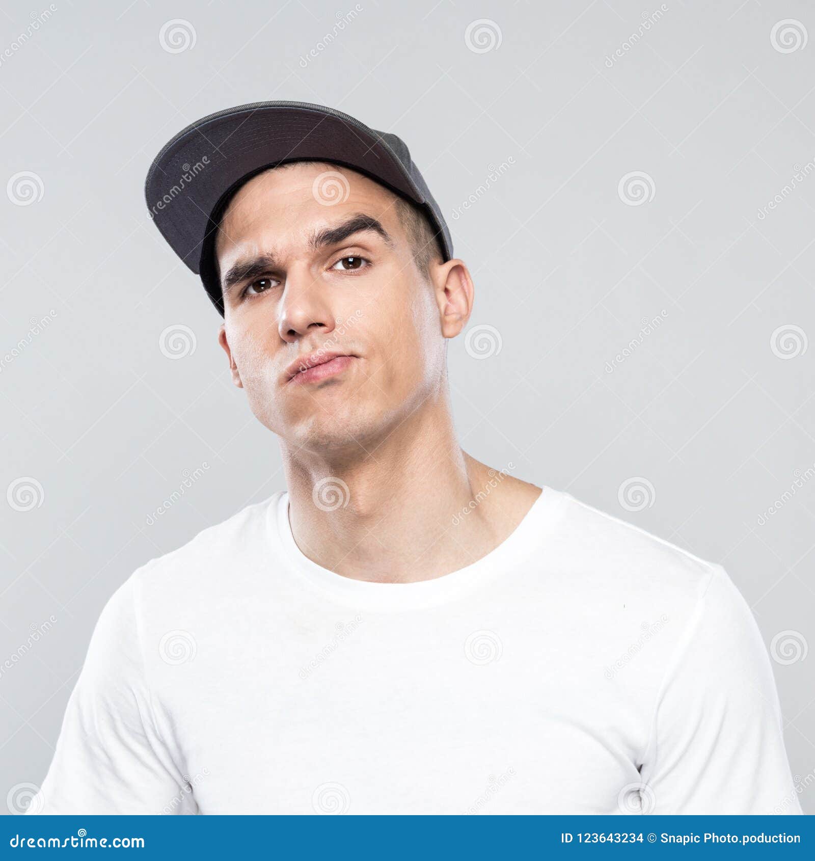 Portrait of Displeased Young Man in Baseball Cap Stock Photo - Image of ... Portrait of Displeased Young Man in Baseball Cap Stock Photo - Image of ...