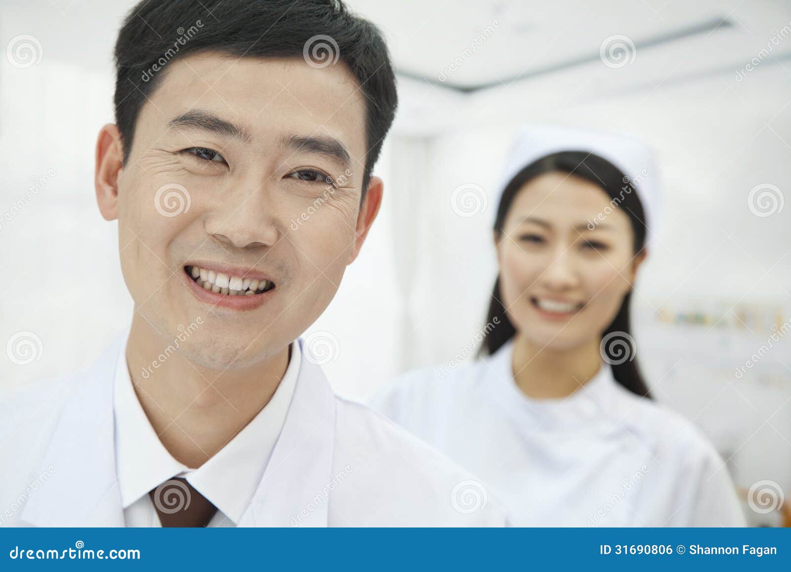 Portrait of Doctor, Nurse in Background Stock Photo - Image of hair ...