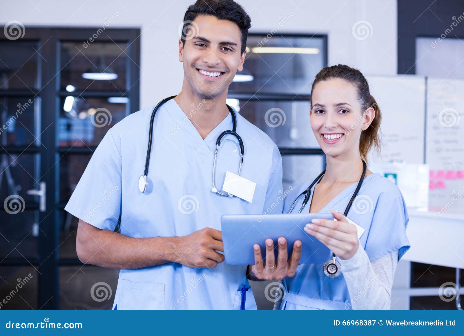 Portrait of Doctors Using Digital Tablet and Smiling Stock Image ...