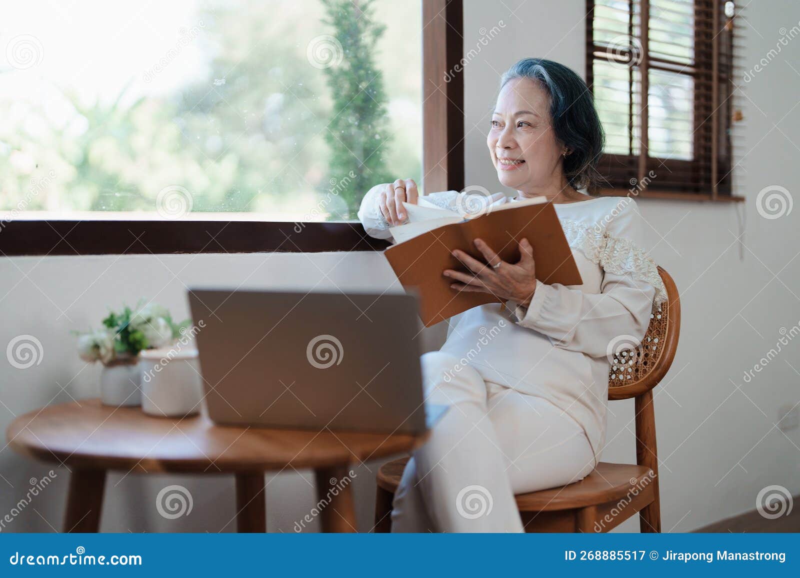 Portrait of an Elderly Asian Woman in a Modern Pose Holding a Memory ...
