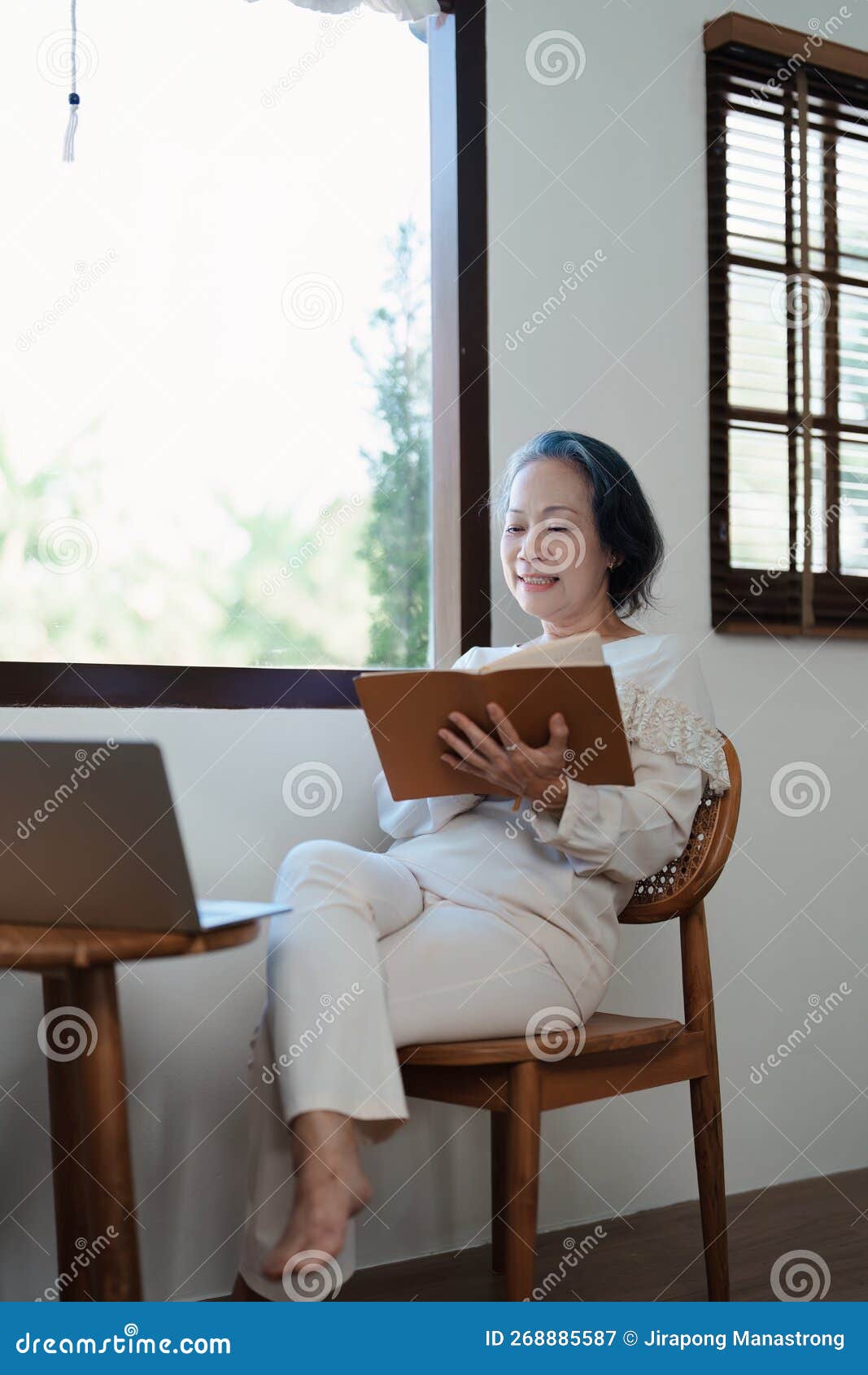 Portrait of an Elderly Asian Woman in a Modern Pose Holding a Memory ...