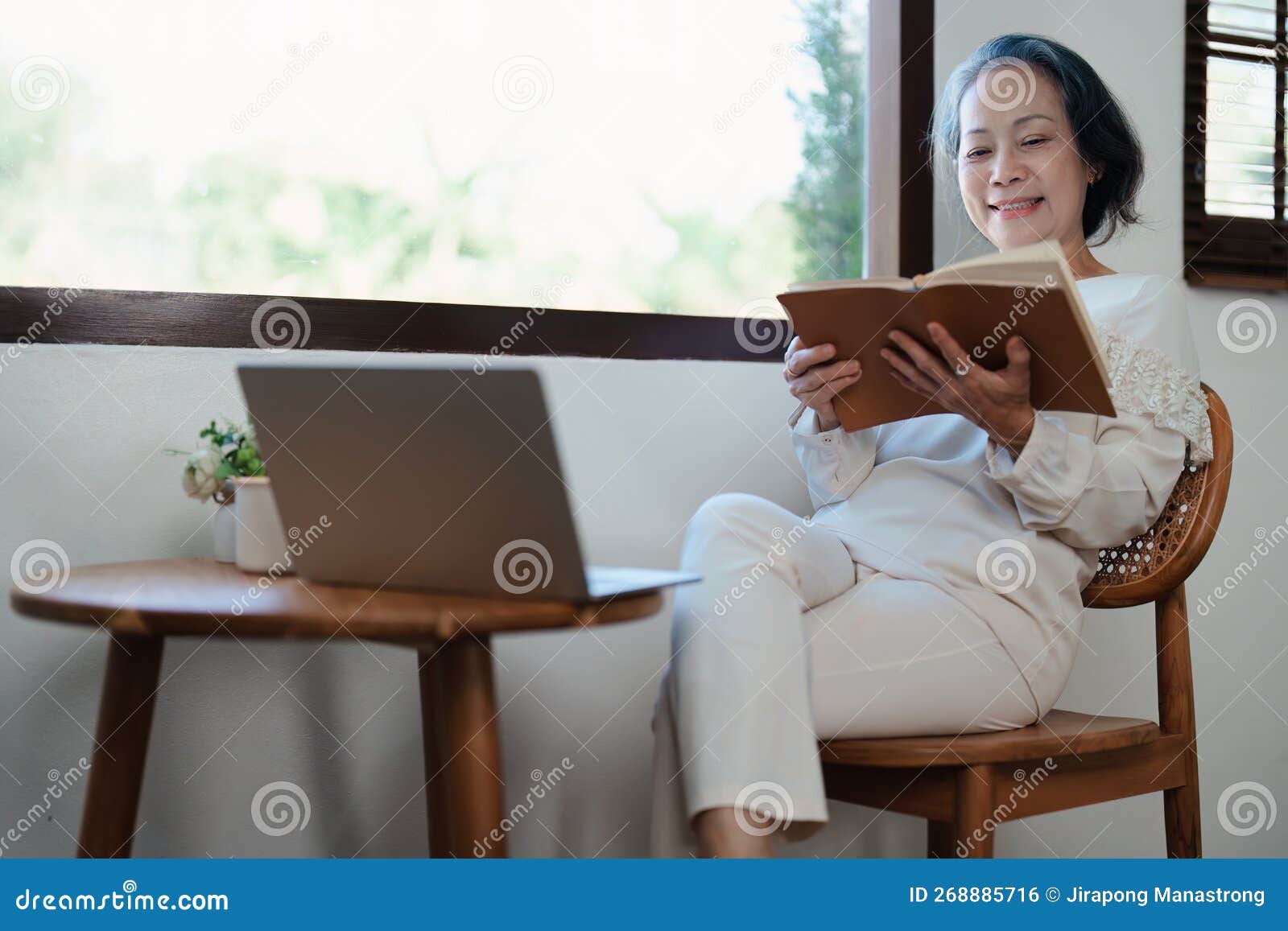 Portrait of an Elderly Asian Woman in a Modern Pose Holding a Memory ...