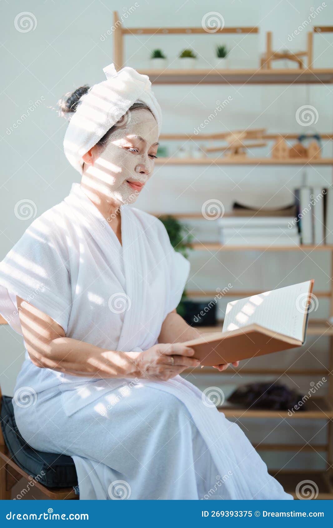 Portrait of Elderly Woman Doing Face Spa Treatment and Using Notebook ...