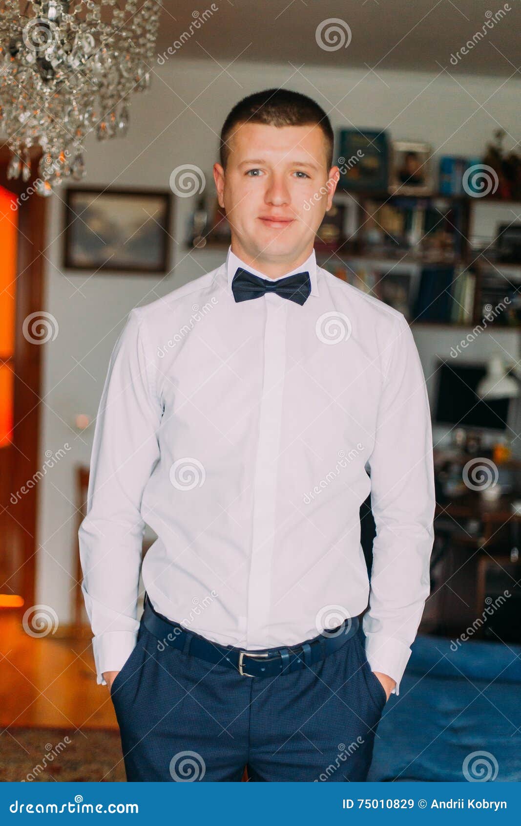 Portrait Of Elegant Young Fashion Man In White Shirt And Bow Tie Stock