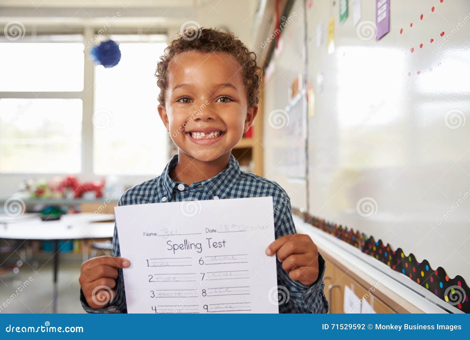 Portrait of Elementary School Boy Holding Up His Test Paper Stock Photo ...
