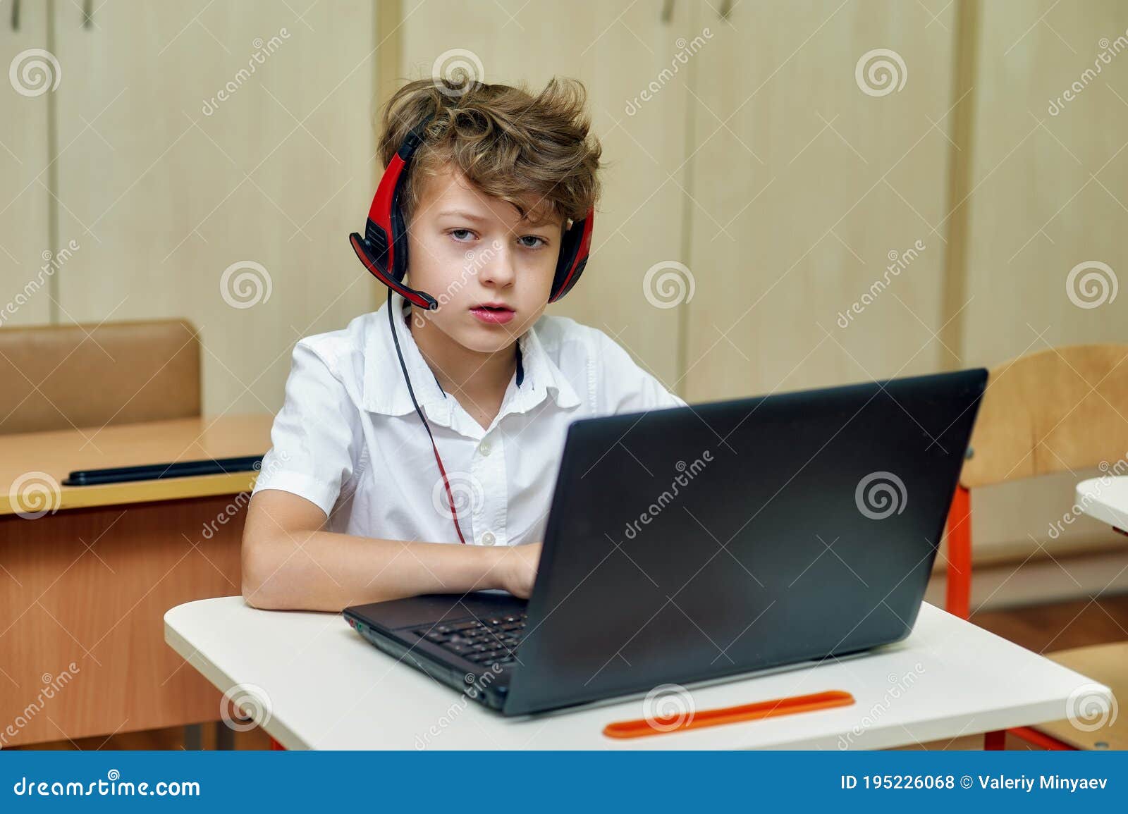 Portrait of an Elementary School Student in the Classroom with a Laptop ...