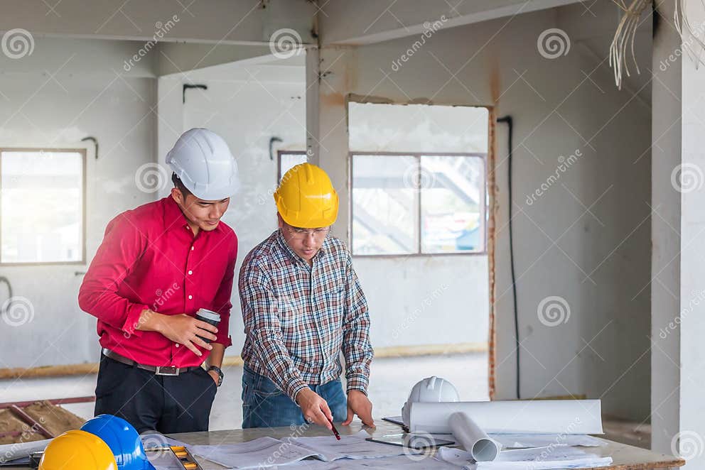 Portrait of Engineer Checking the Blueprint on Table and Talking about ...