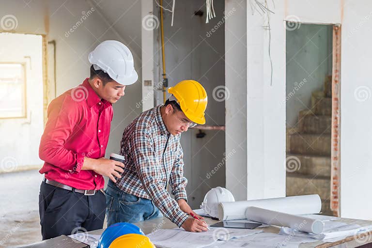 Portrait of Engineer Checking the Blueprint on Table and Talking about ...