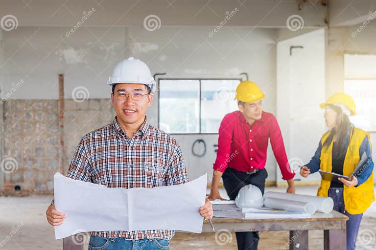 Portrait of Engineer Checking the Blueprint and Talking about ...