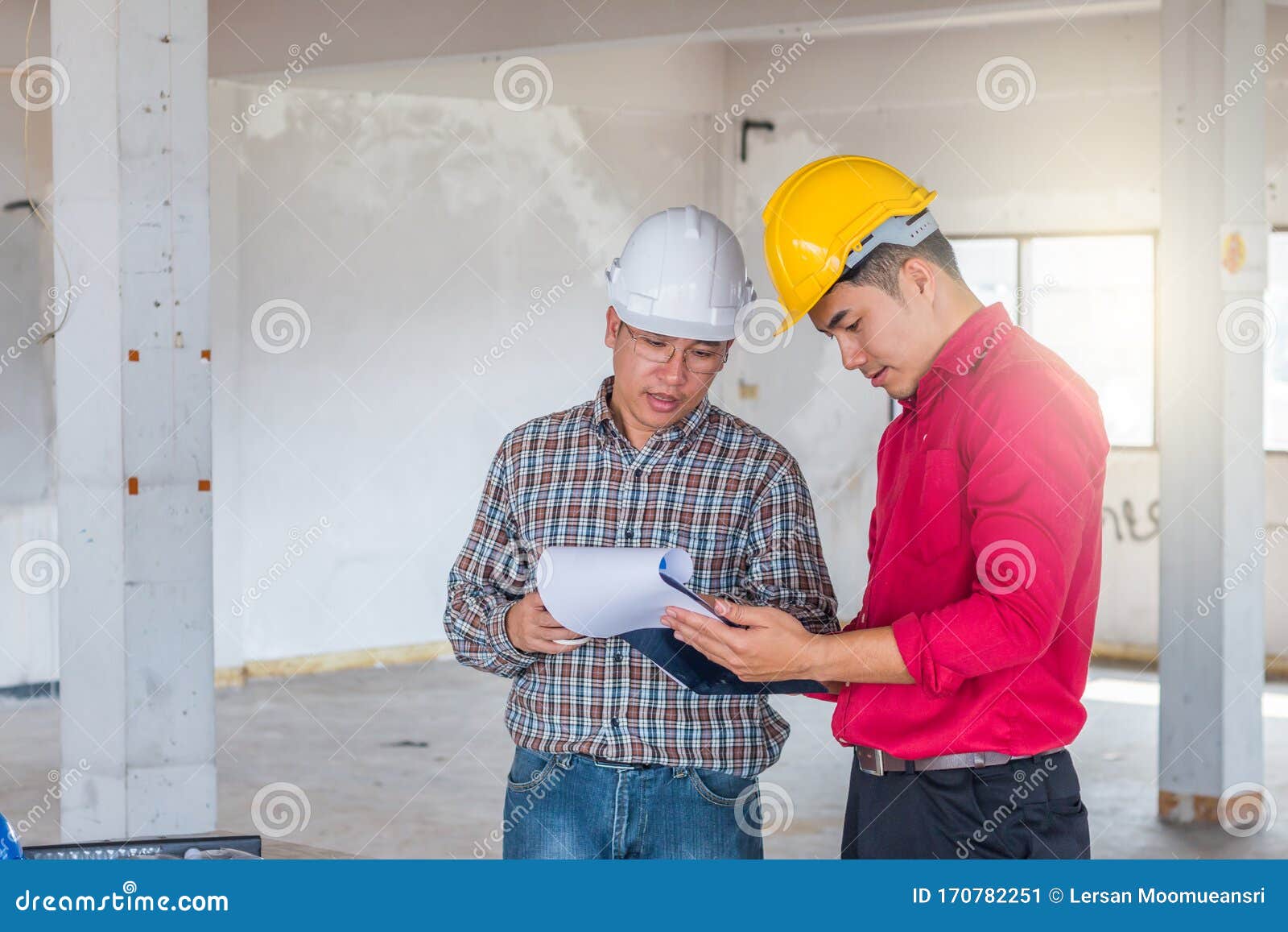 Portrait of Engineer Checking the Job and Talking about Project with ...