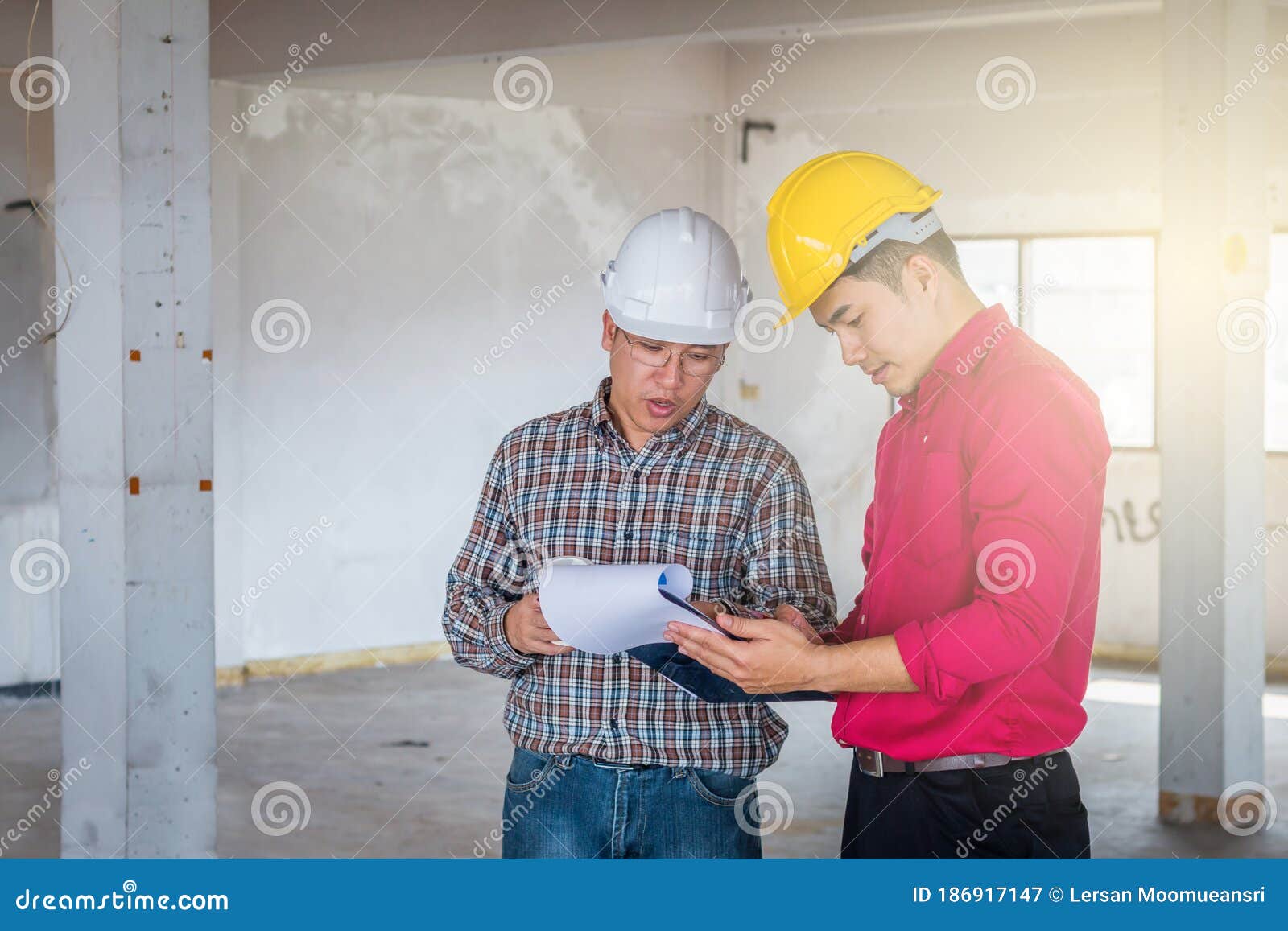 Portrait of Engineer Checking the Job and Talking about Project with ...