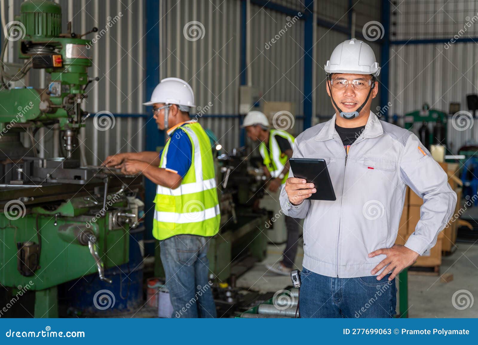 Portrait of Engineer Checking Worker Operating Lathe Grinding Machine ...