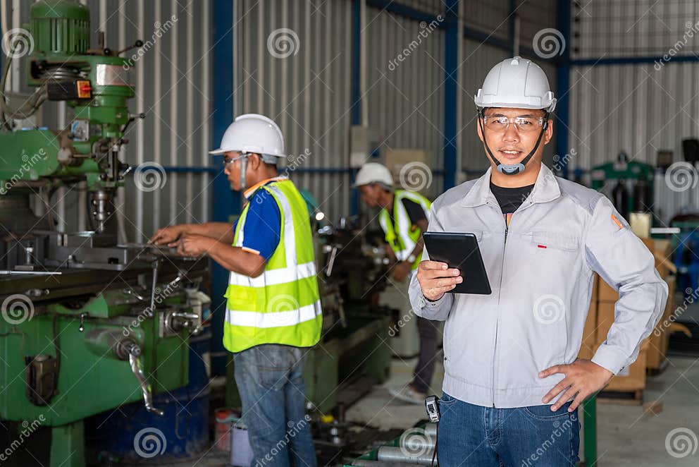 Portrait of Engineer Checking Worker Operating Lathe Grinding Machine ...