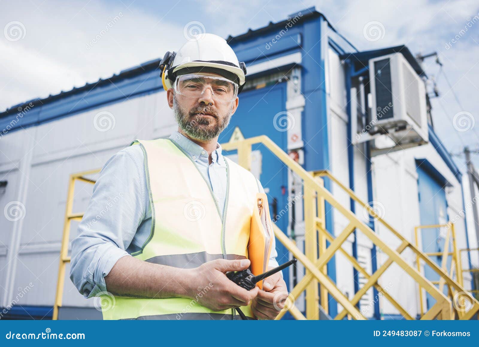 Portrait of Engineer Using Walkie-talkie Talking in Production Site ...