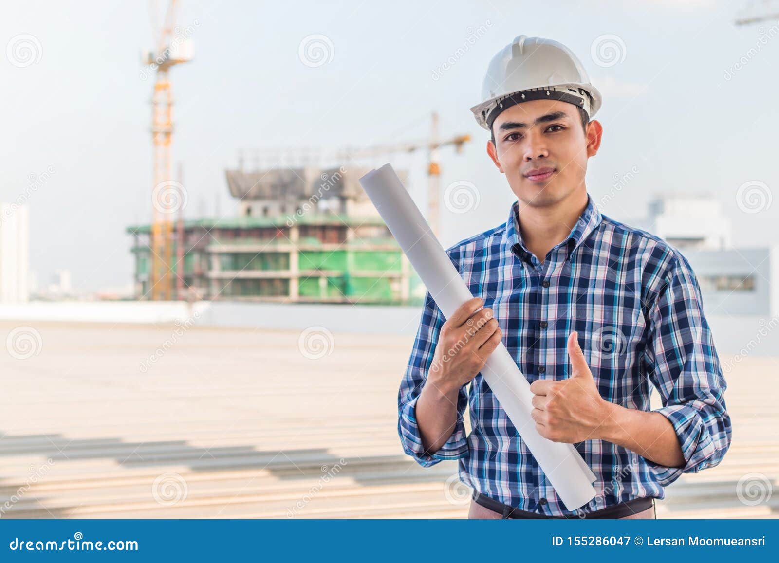 Portrait of Engineer Wear Blue Safety Helmet and Hold the Blueprint ...