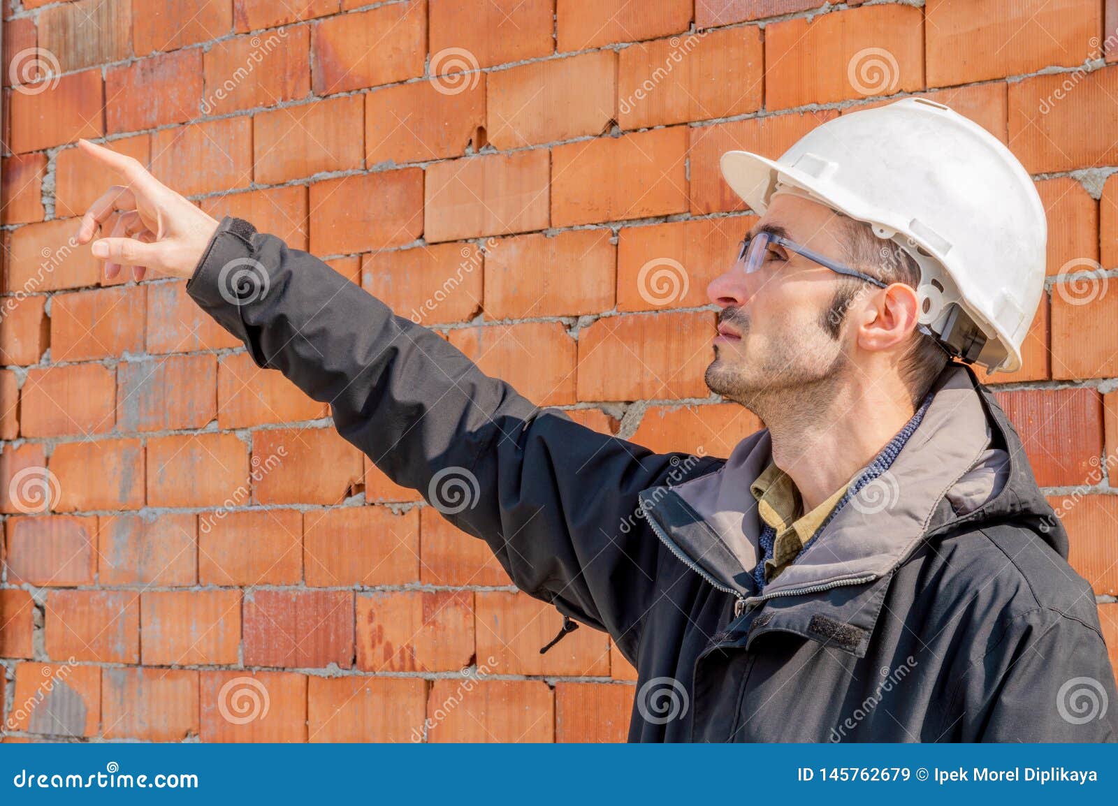 Portrait of an Engineer Wearing Hardhat at the Construction Site Stock ...